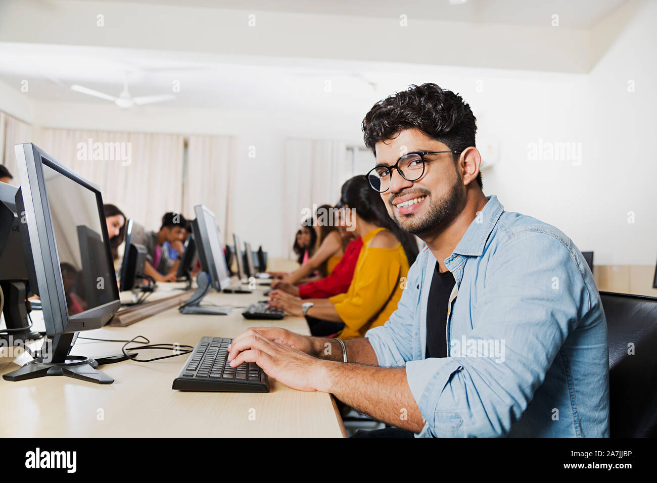 College Boy Student Working on Computer Studying E-Learning With ...
