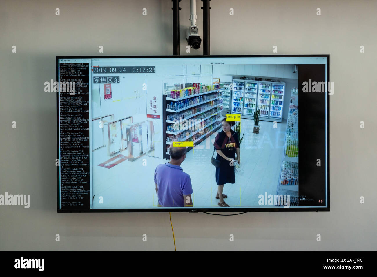 A monitor screen detects shoppers in the convenient store in Shanghai ...