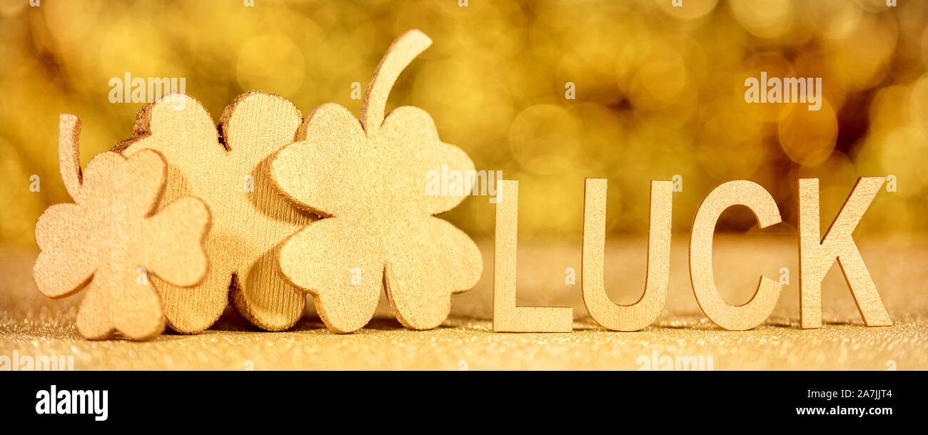 panorama with three shamrocks in front of shiny golden background Stock ...