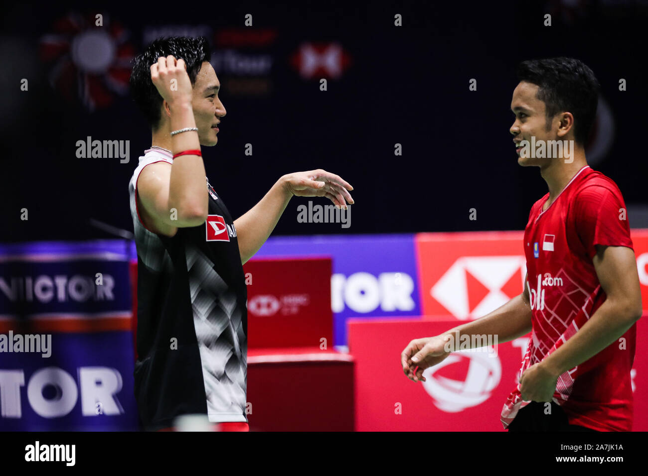Japanese professional badminton player Kento Momota, left, and Indonesian professional badminton ...