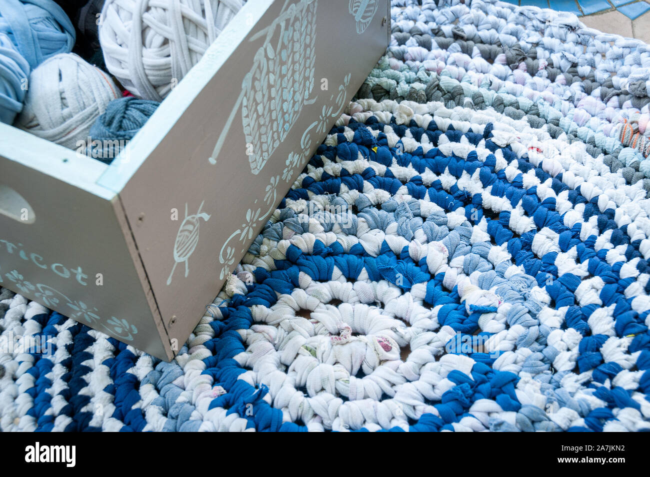 blue and white rag rug and teeshirt wool room for text Stock Photo - Alamy