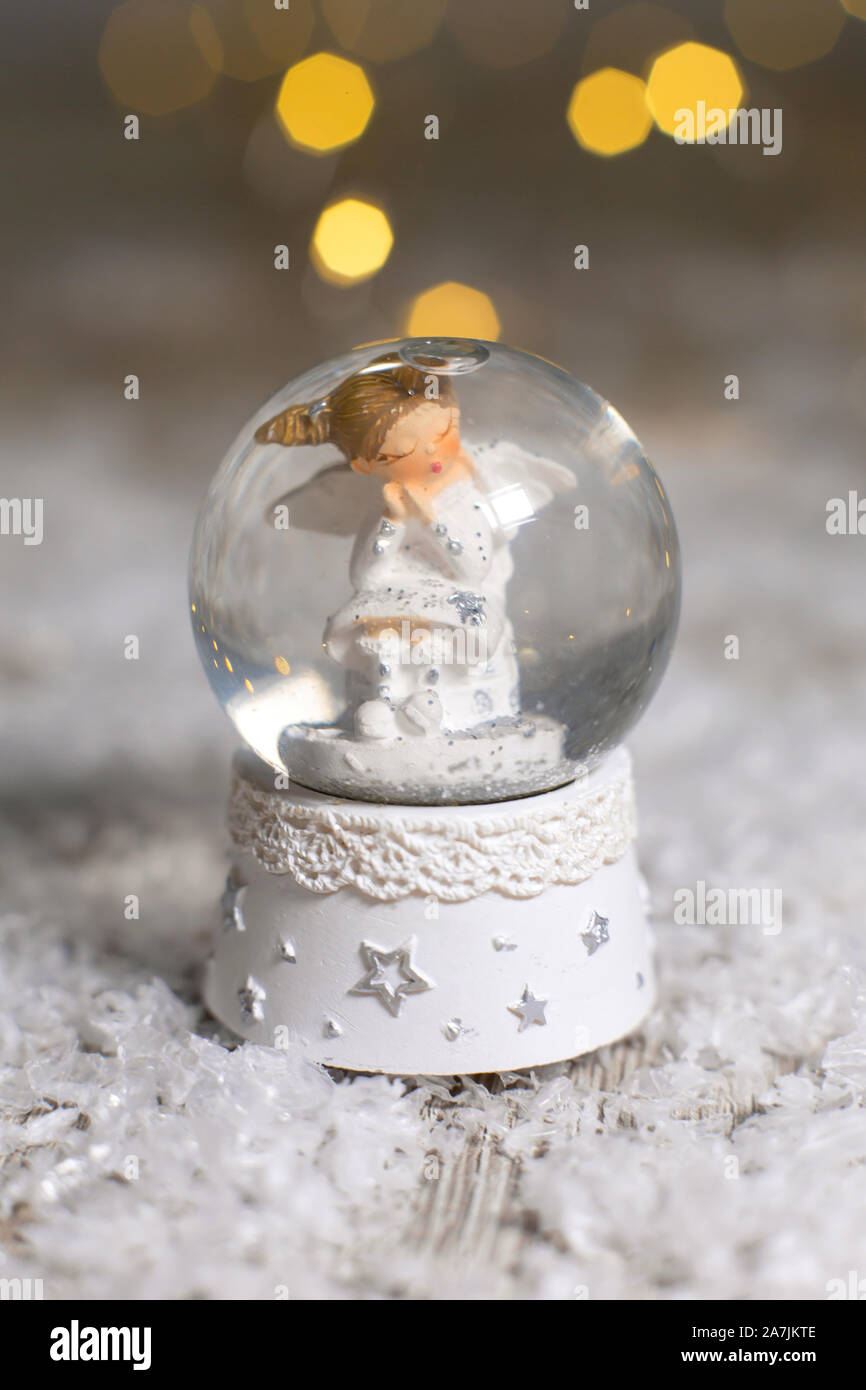 Decorative Christmas-themed figurines. Glass ball with snowflakes in ...