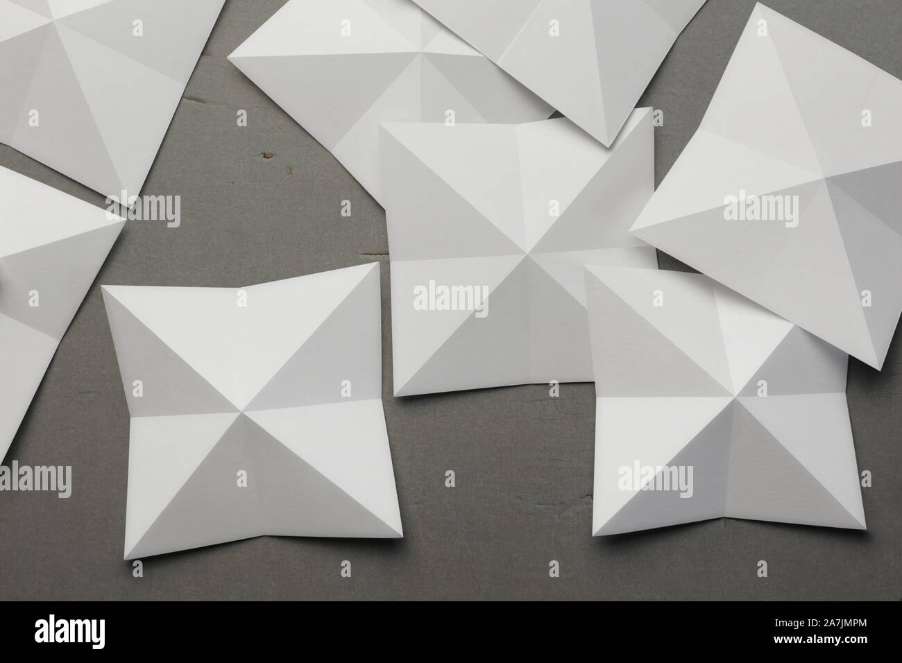 White paper folded in geometric shapes, abstract background Stock Photo ...