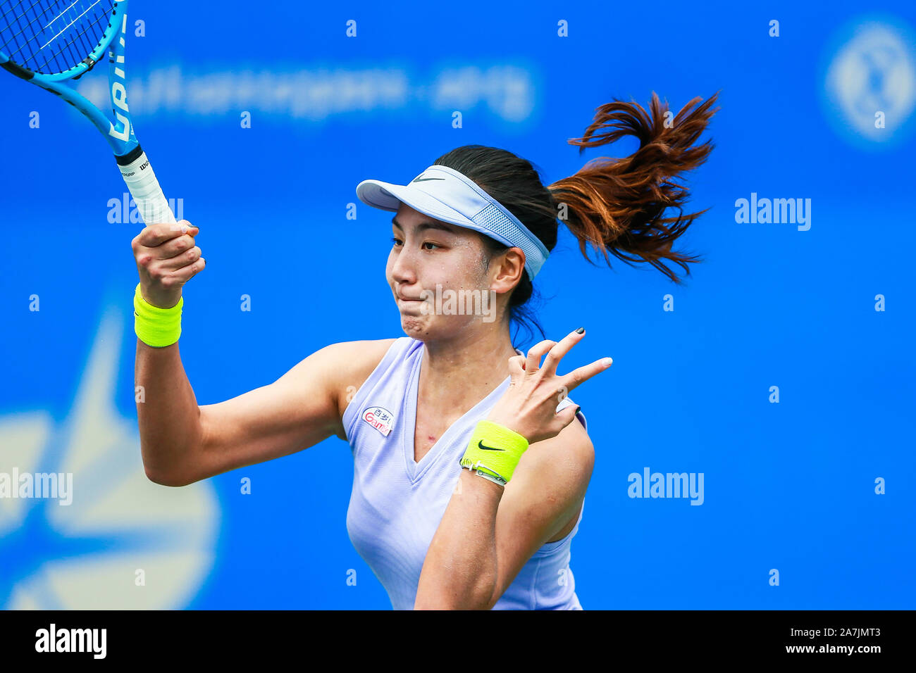 Wang Xinyu of China gets the ball against Kurumi Nara of Japan at the ...