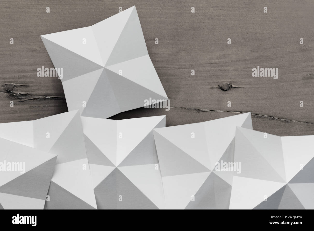 White paper folded in geometric shapes, abstract background Stock Photo ...