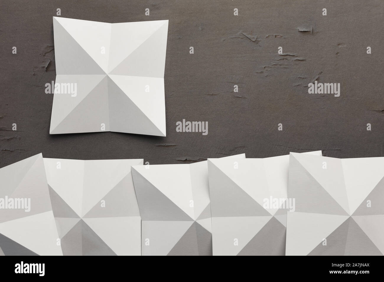 White paper folded in geometric shapes, abstract background Stock Photo ...