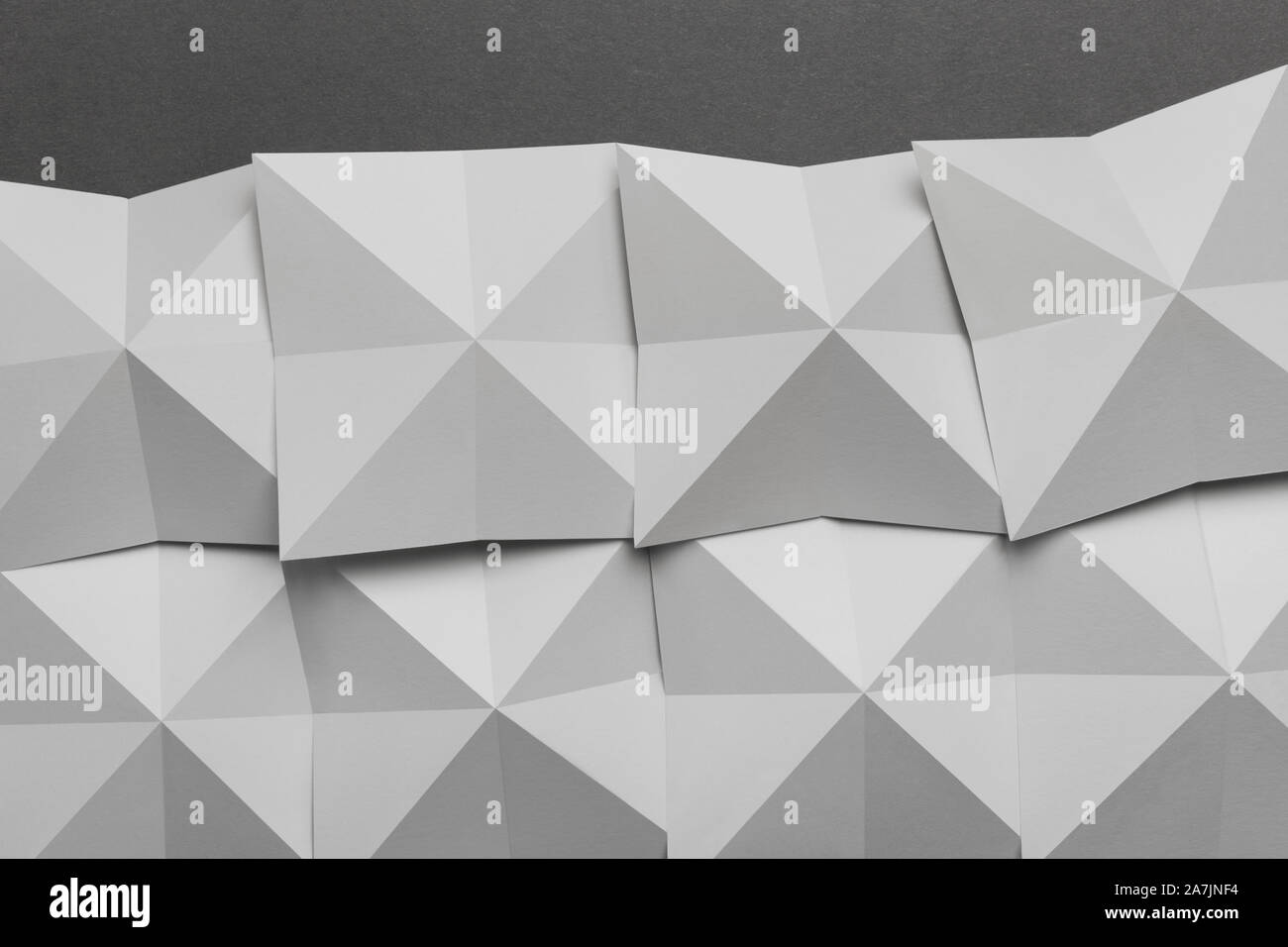 White paper folded in geometric shapes, abstract background Stock Photo ...