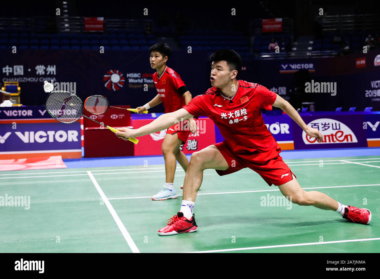 Chinese professional badminton players Wang Yilv and Huang Dongping compete against Japanese ...