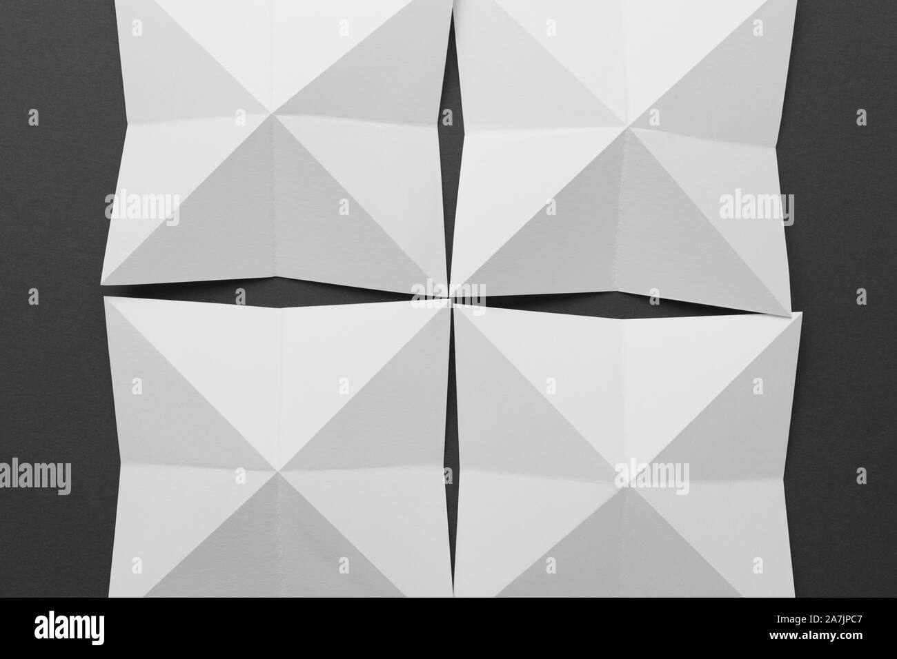 White paper folded in geometric shapes, abstract background Stock Photo ...