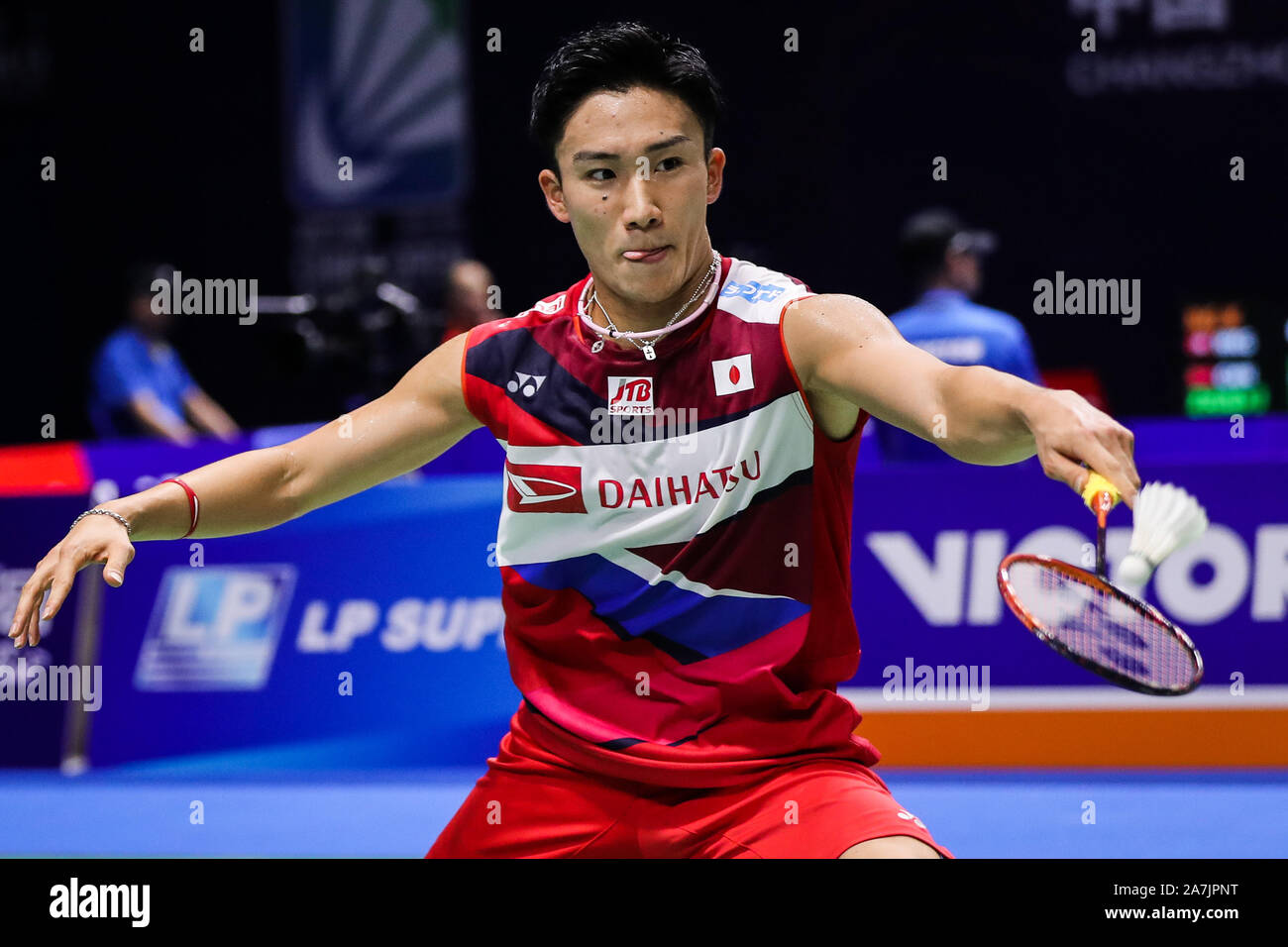 Japanese professional badminton player Kento Momota competes against ...