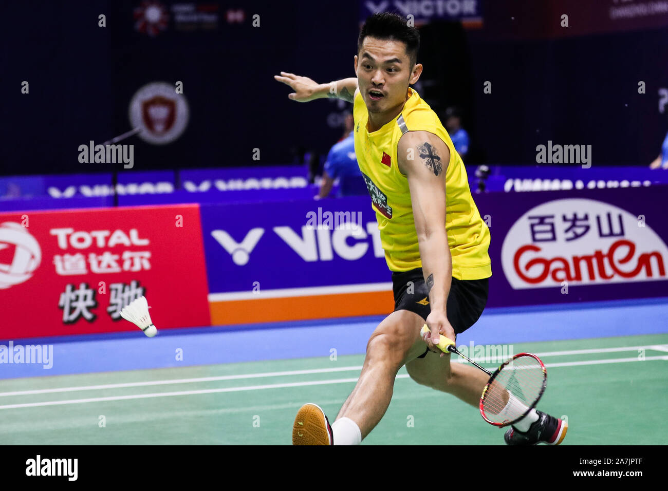 Chinese professional badminton player Lin Dan competes against Japanese ...