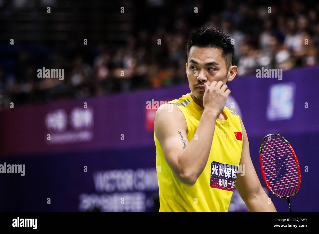 Chinese professional badminton player Lin Dan competes against Japanese ...