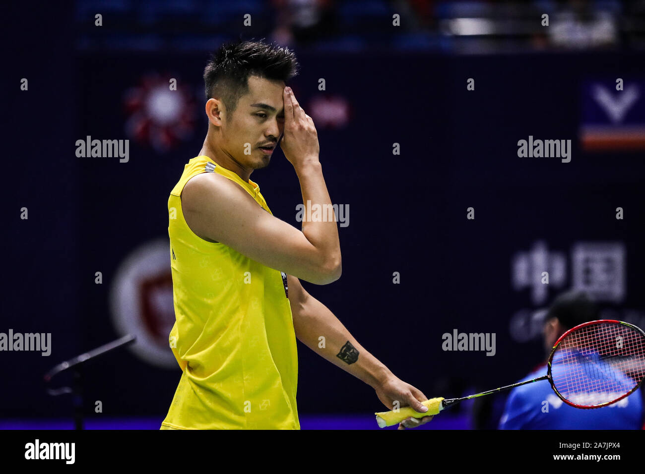 Chinese professional badminton player Lin Dan competes against Japanese ...