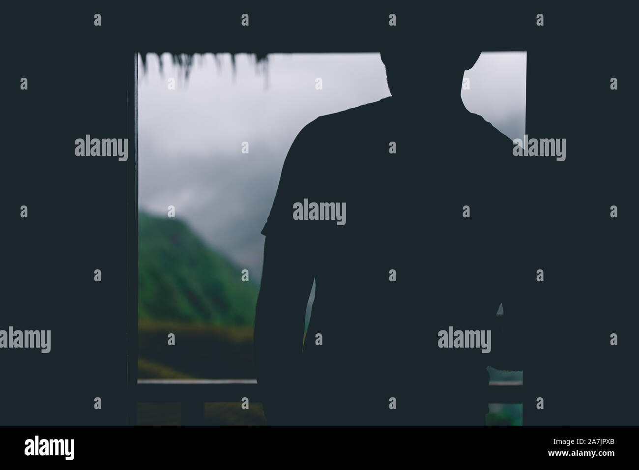 White adult male looking out through a doorway from a cabin over a ...