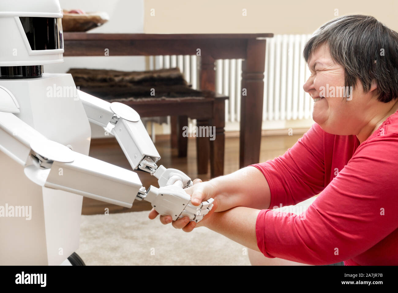 medical service robot is giving a mentally disabled woman the hand ...