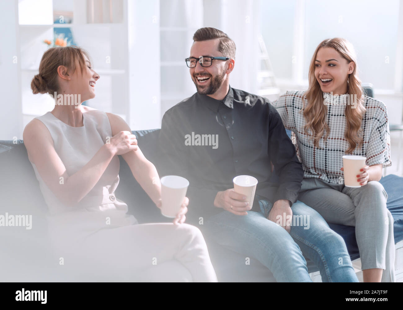 Colleagues making a coffee break in an office lobby Stock Photo - Alamy