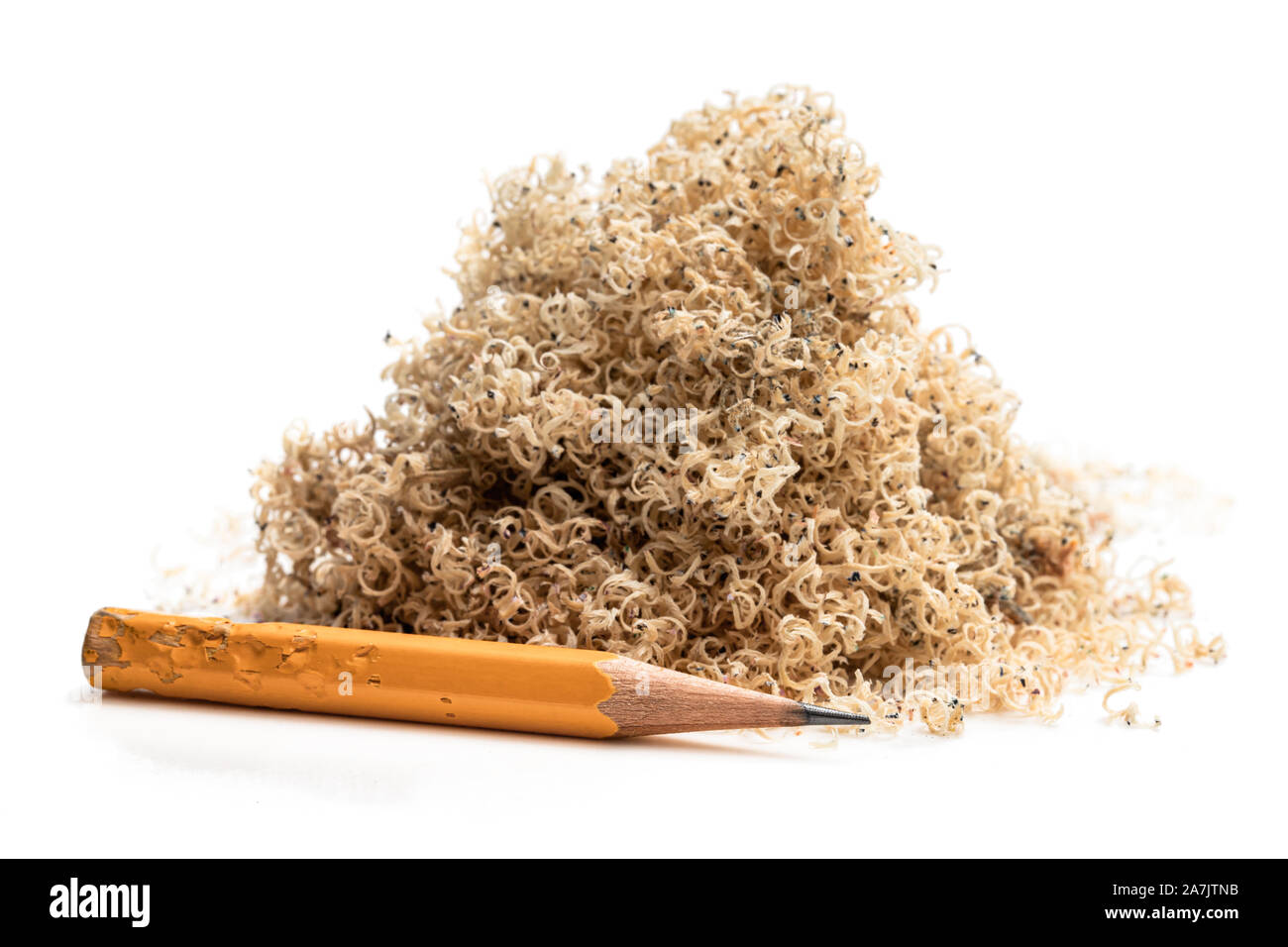 Oversharpened pencil in front of the heap of shavings. Concept of the ...