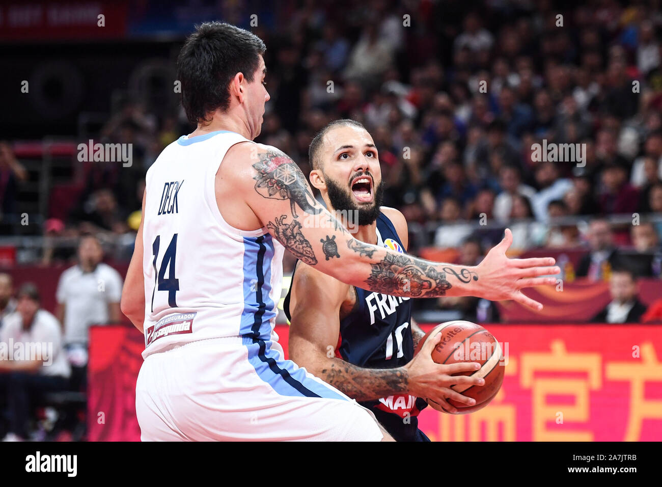 Evan Fournier of France, right, keeps the ball during semifinal match ...