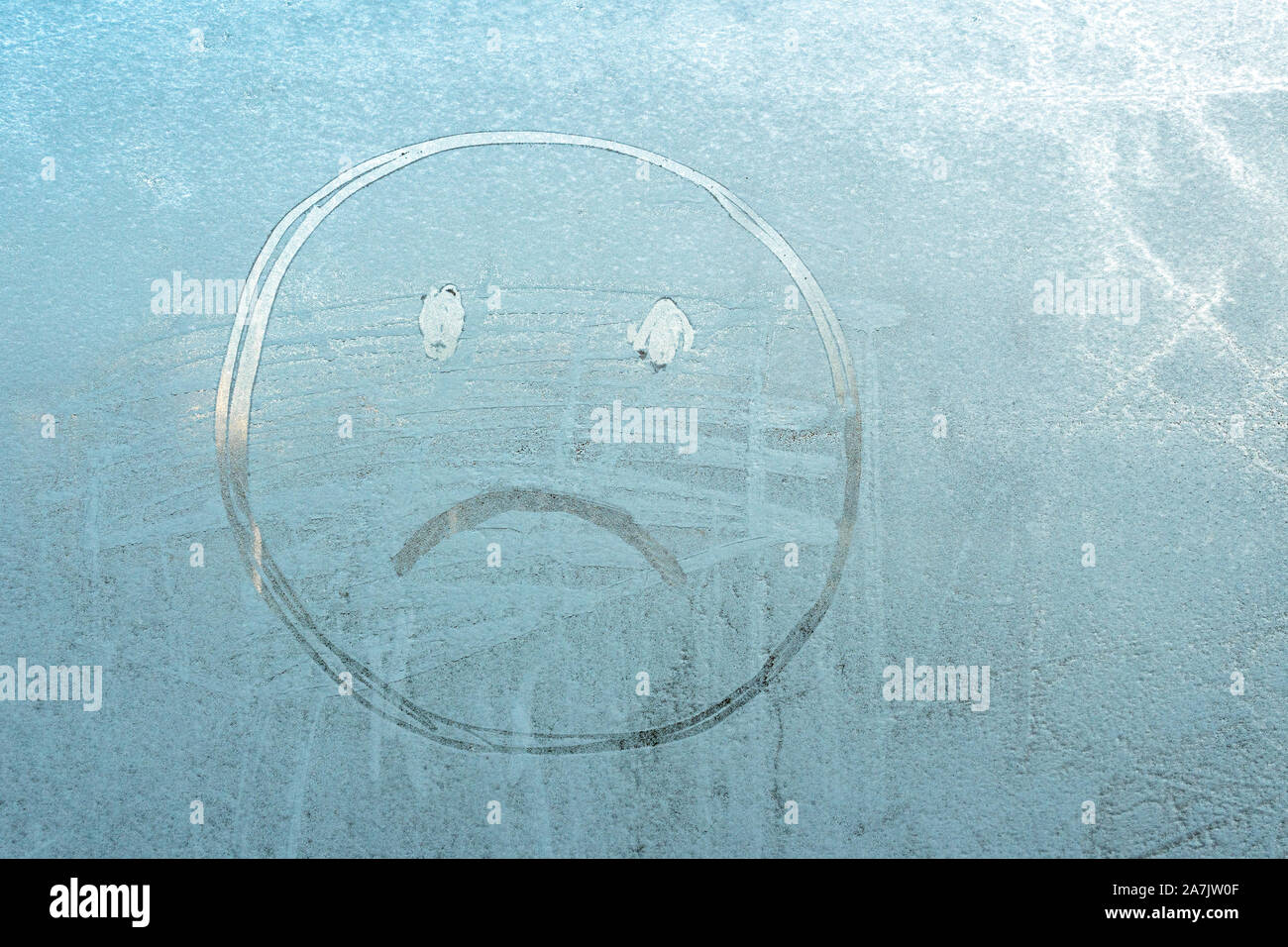 sad smiley face on a frozen window covered with frost Stock Photo - Alamy