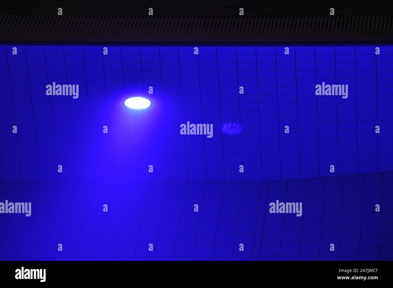 Night illumination of the swimming pool. Blue light. Pool at night ...