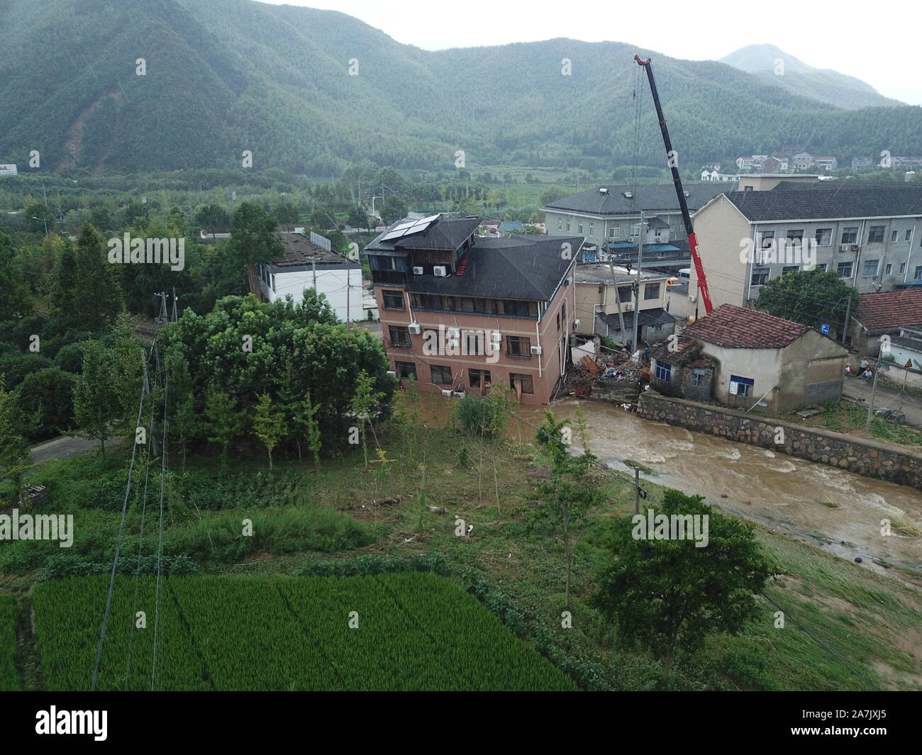 A house tilts to the river due to heavy rainstorm caused by Typhoon ...