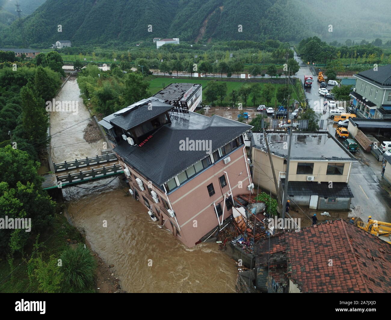 A house tilts to the river due to heavy rainstorm caused by Typhoon ...