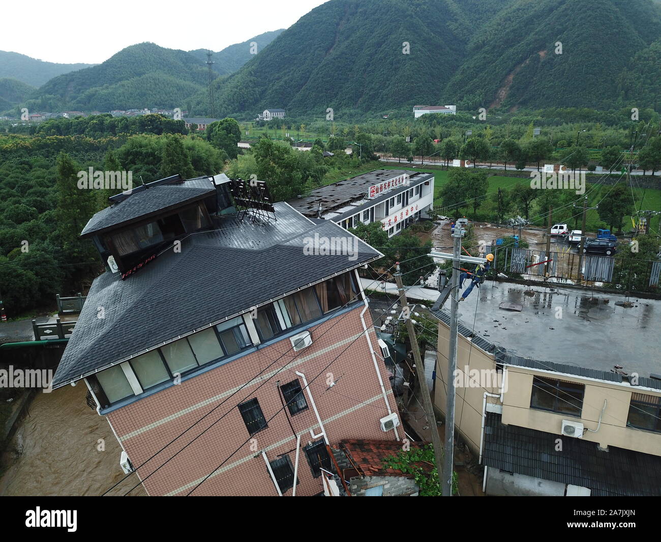 A house tilts to the river due to heavy rainstorm caused by Typhoon ...