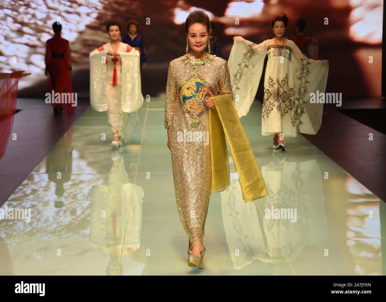 Elder models wearing traditional Chinese outfit designed by Chen Fumei ...