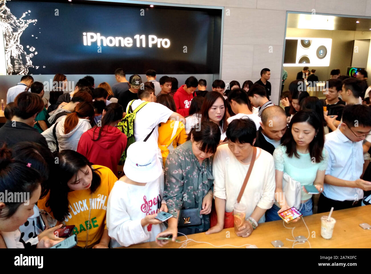 The Apple retail store is crowded with fans waiting to experience the ...