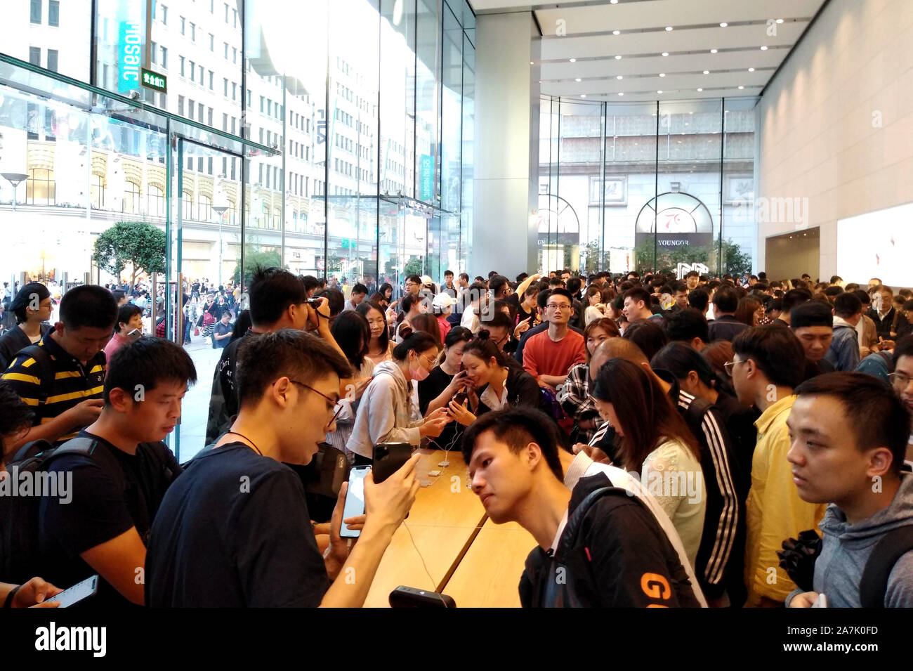 The Apple retail store is crowded with fans waiting to experience the ...