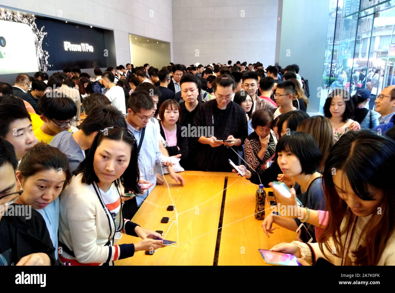 The Apple retail store is crowded with fans waiting to experience the ...
