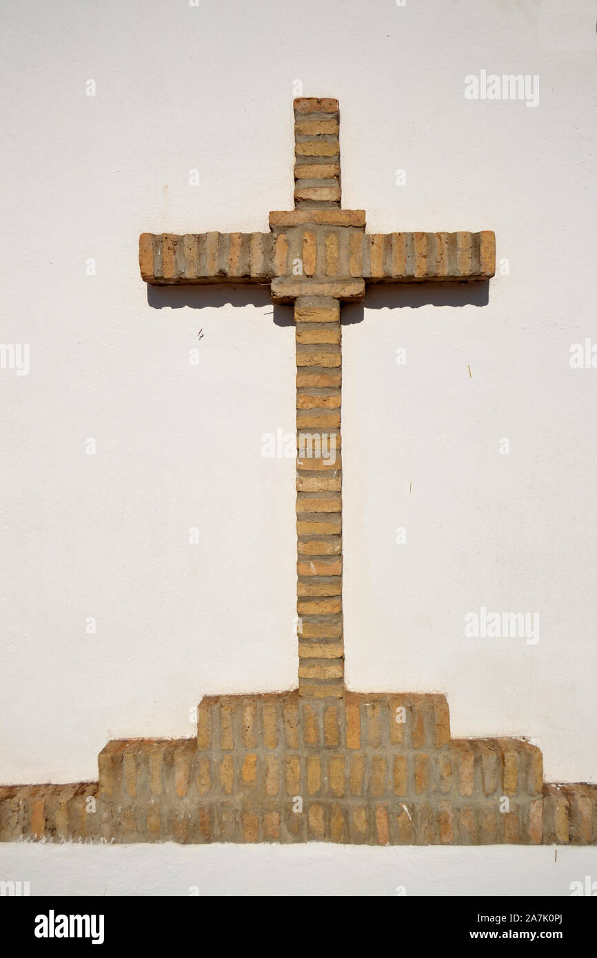 Christian Cross of bricks on a white background in an enclosure to ...