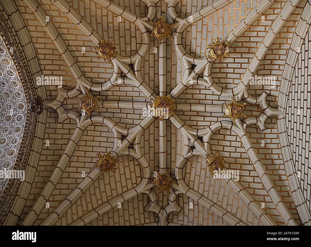 Roof of a building decorated with white bricks, medieval emblems and ...