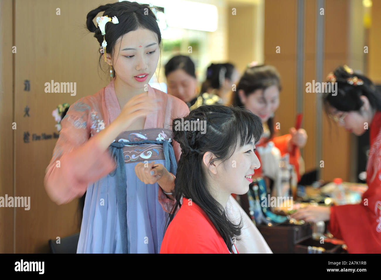 Beauties dressing in ancient Chinese clothes prepare to demonstrate and ...