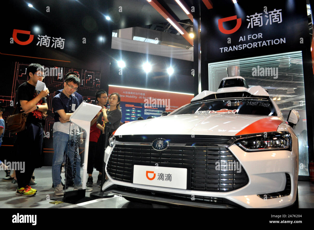 People look at "Robotaxi", the Chinese transportation company DiDi's ...