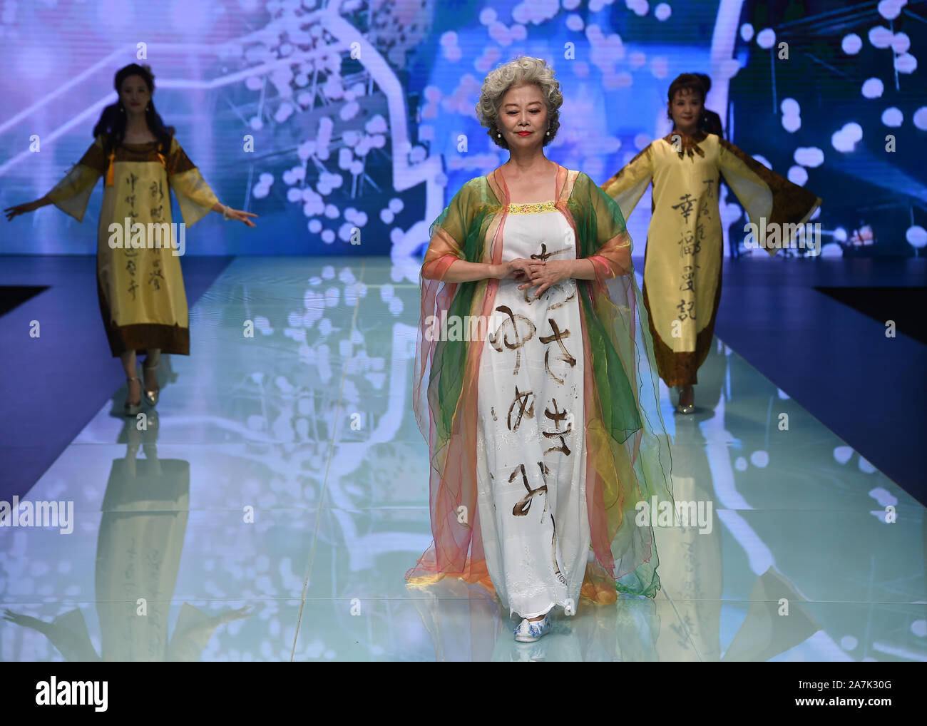 Elder models wearing traditional Chinese outfit designed by Chen Fumei ...