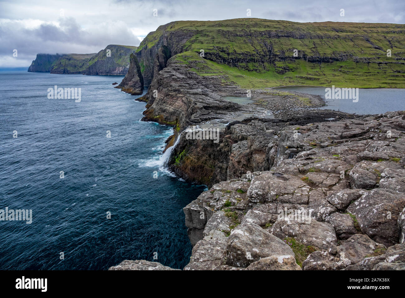 Bosdalafossur waterfall to the ocean on Vagar island coastline Stock ...