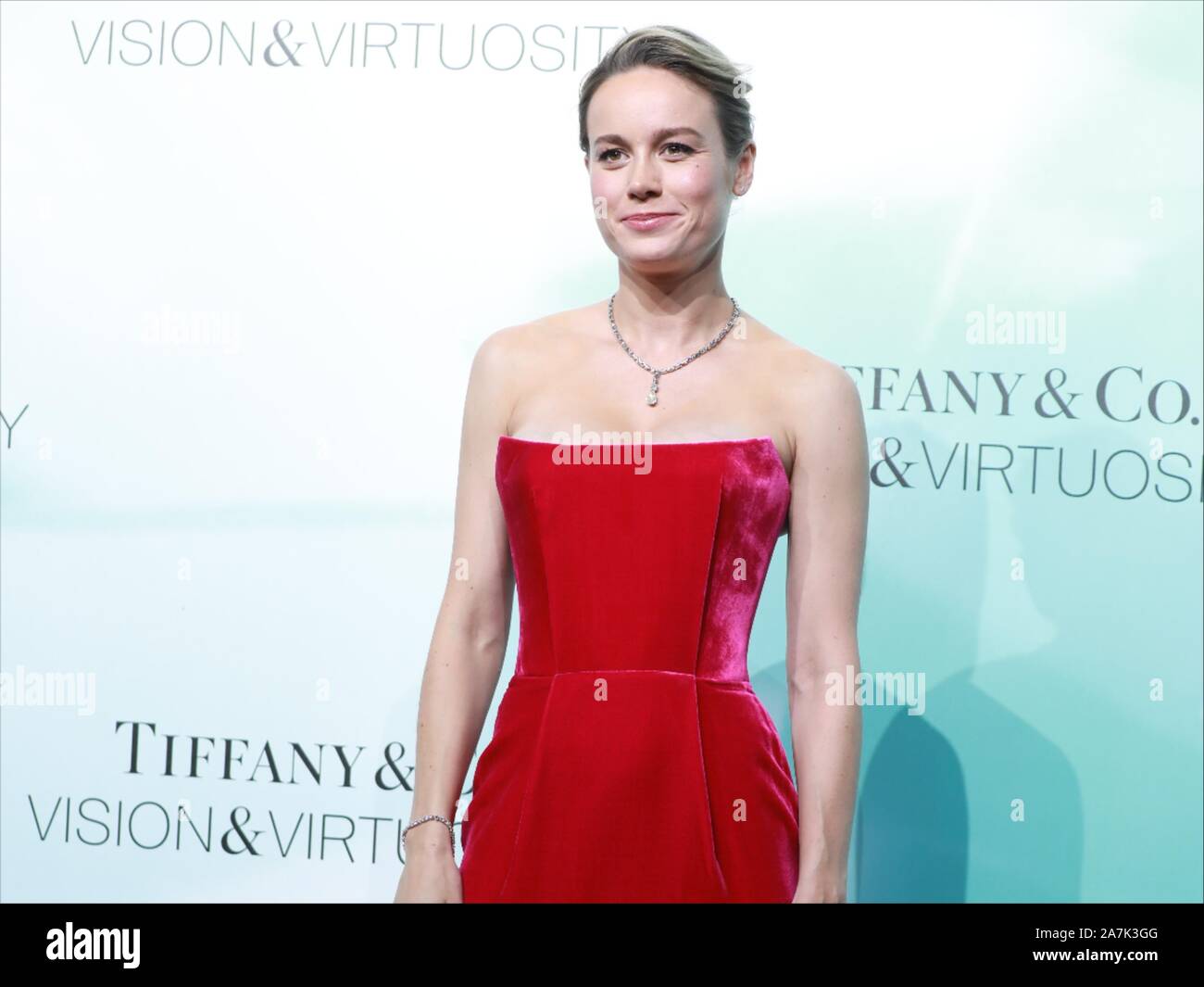 American actress and filmmaker Brie Larson wears a red dress to attend ...