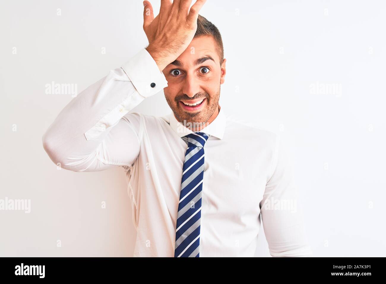 Young handsome elegant business man over isolated background surprised ...
