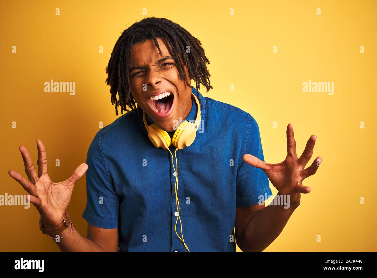 Afro american man with dreadlocks wearing headphones over isolated ...