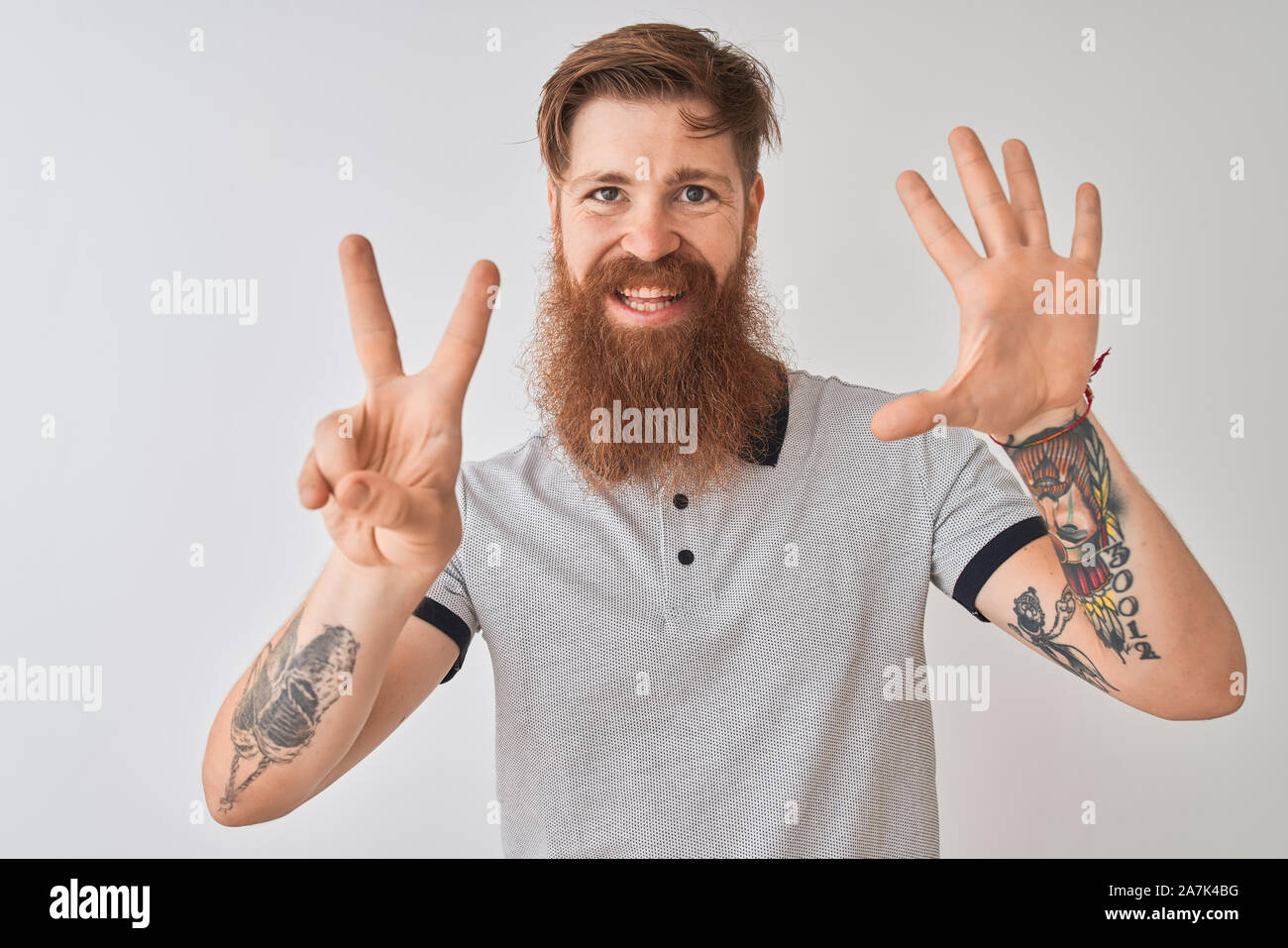 Young redhead irish man wearing grey polo standing over isolated white ...