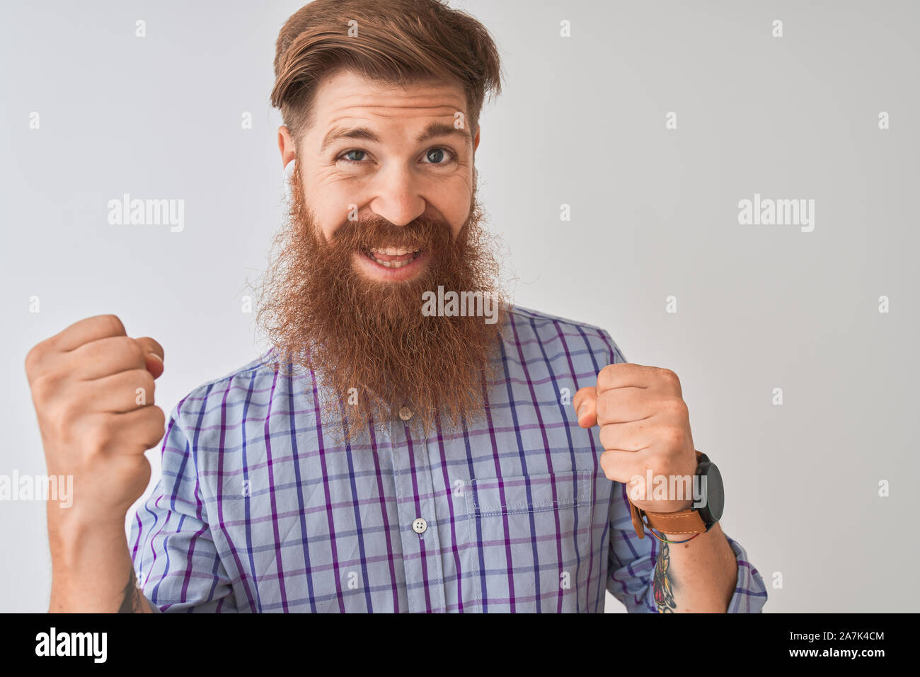 Redhead irish man listening to music using wireless earphones over ...