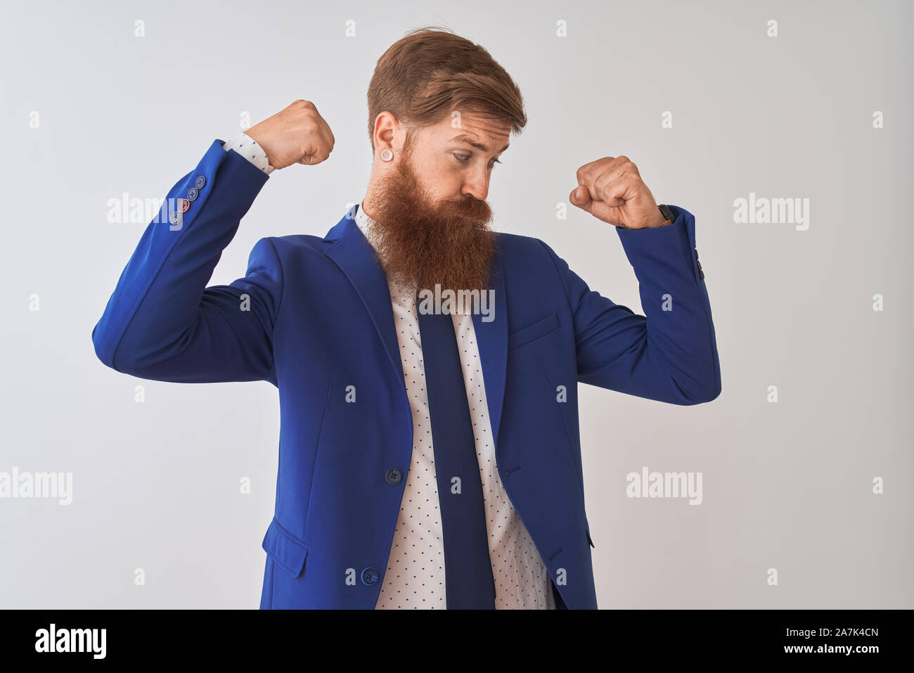 Young redhead irish businessman wearing suit standing over isolated ...