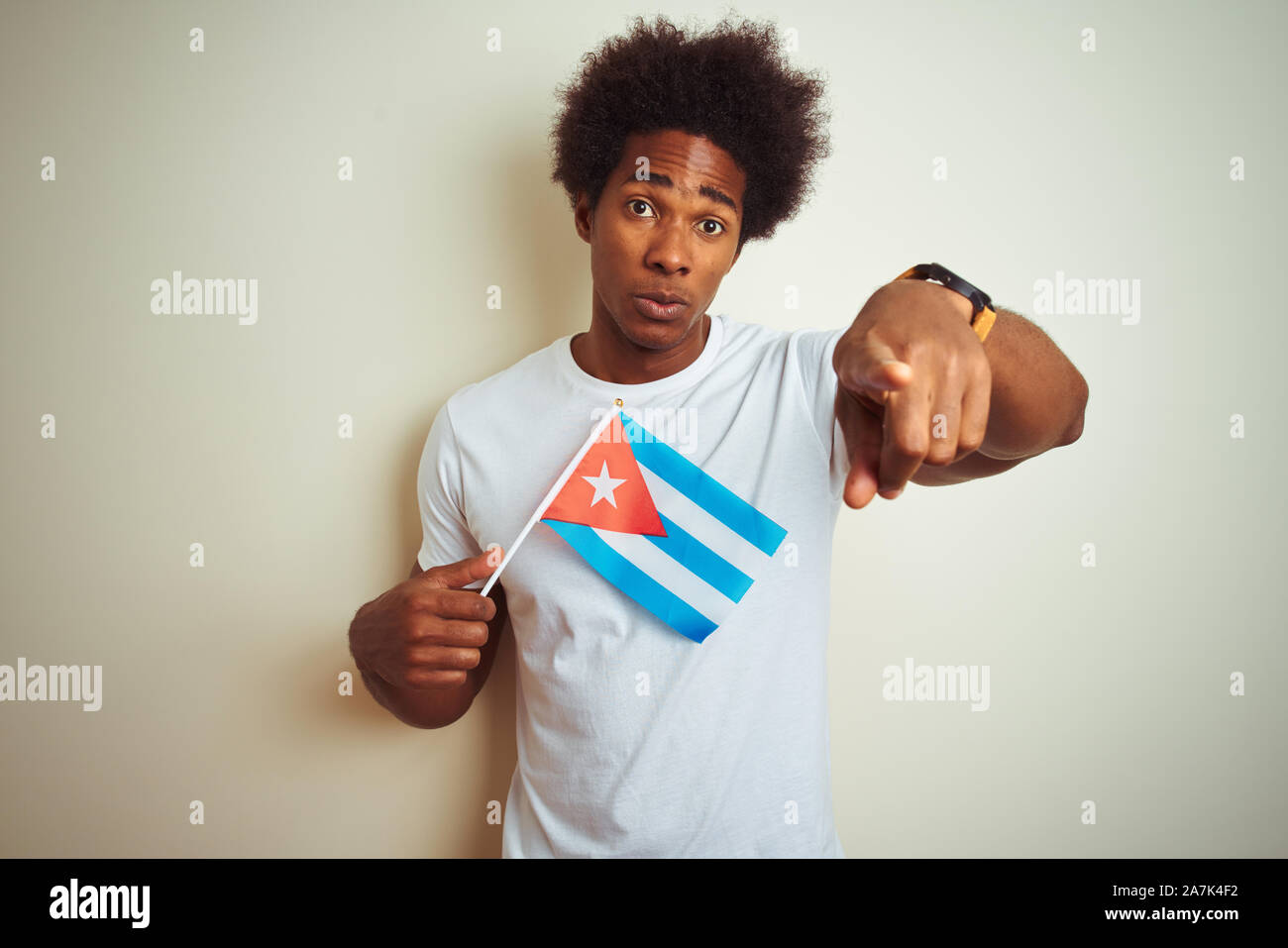 Young african american man holding Cuba Cuban flag standing over ...