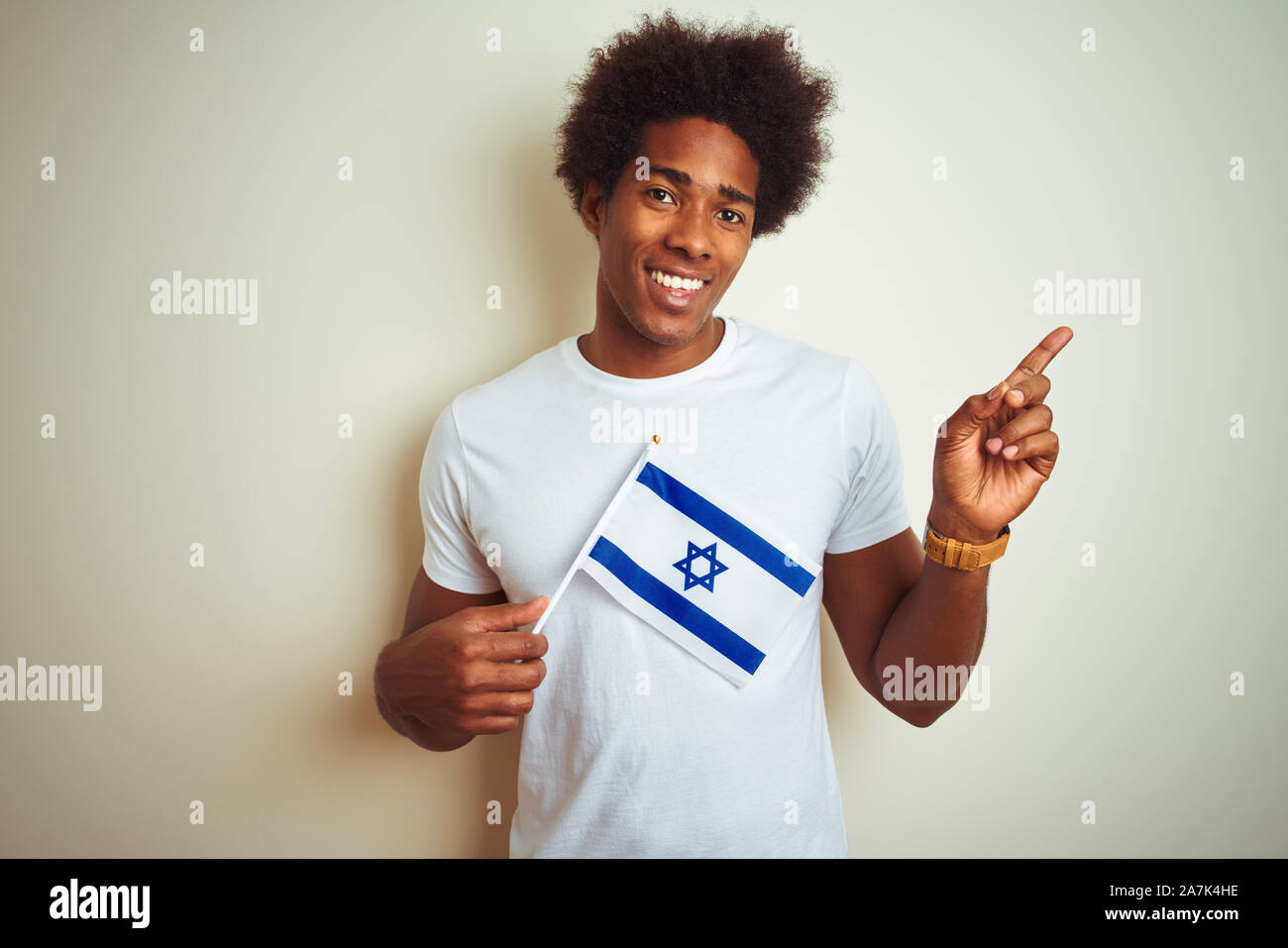 Young african american man holding Israel Israeli flag standing over ...
