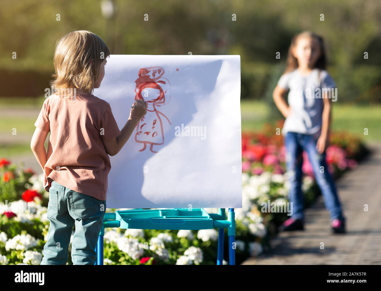 Brother and sister paint funny portraits of people with paints on paper ...