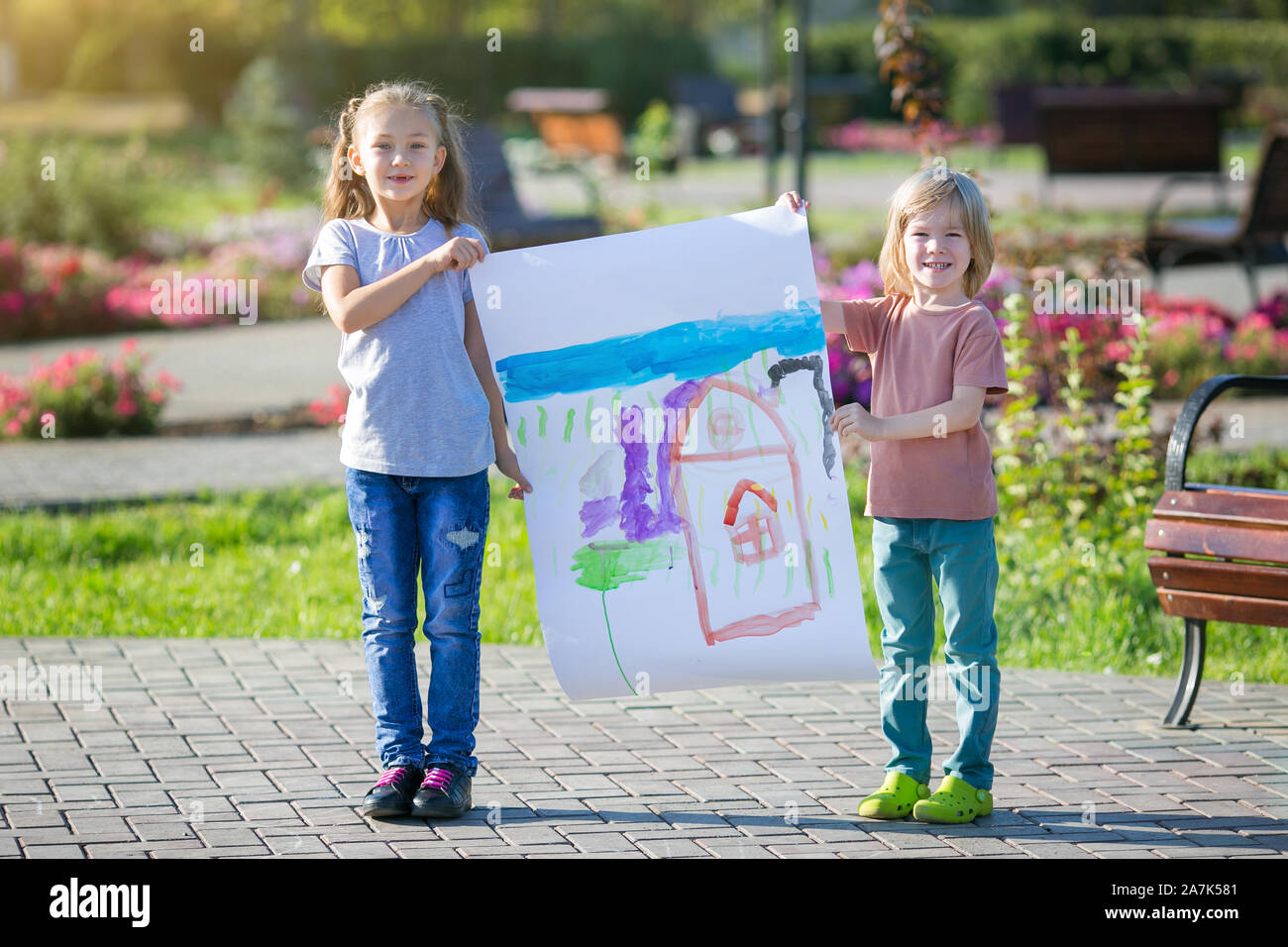 Preschool children have drawn a drawing and hold it in their hands ...