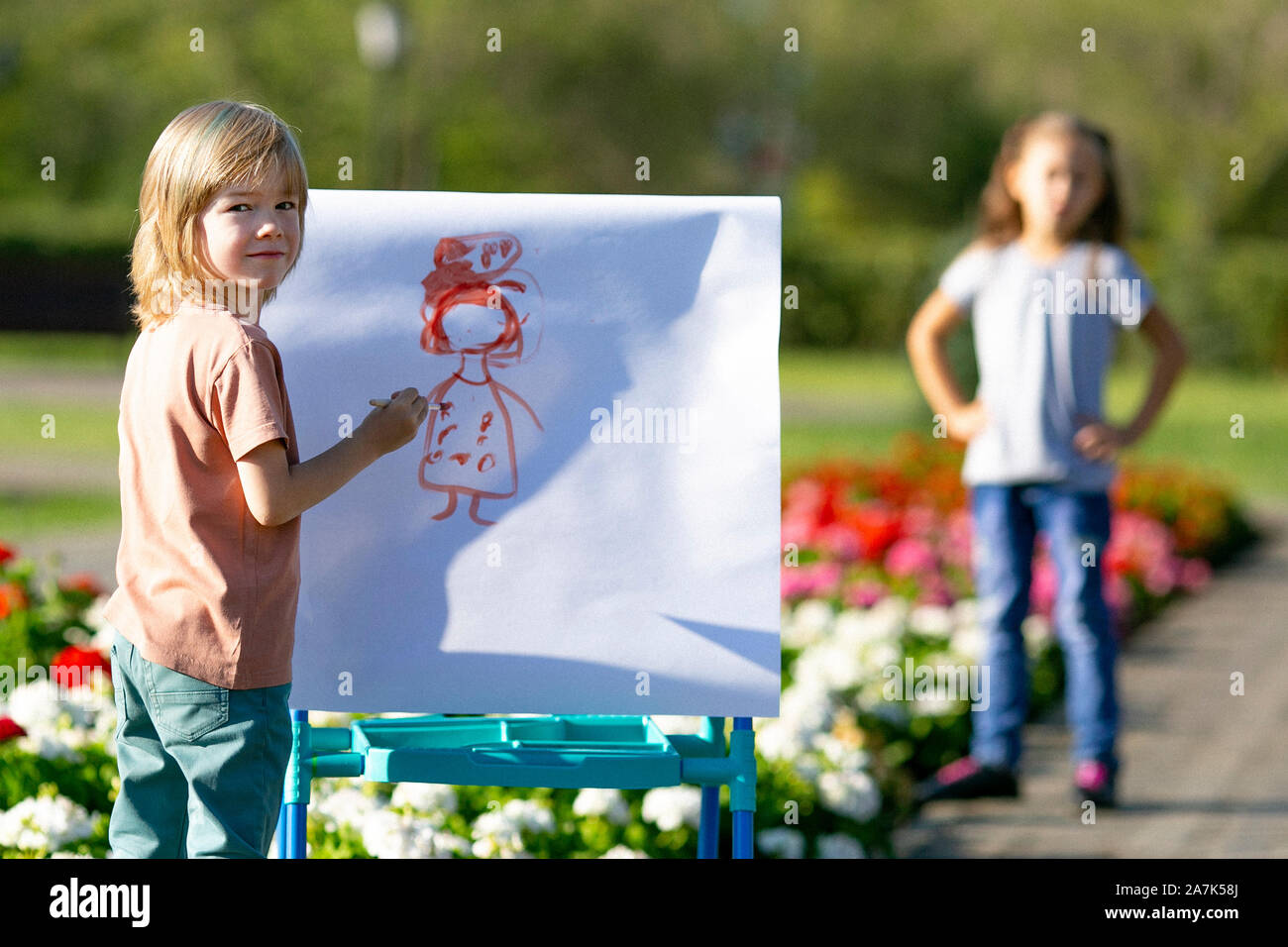 Brother and sister paint funny portraits of people with paints on paper ...
