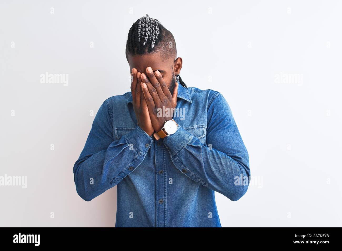African american man with braids wearing denim shirt over isolated ...