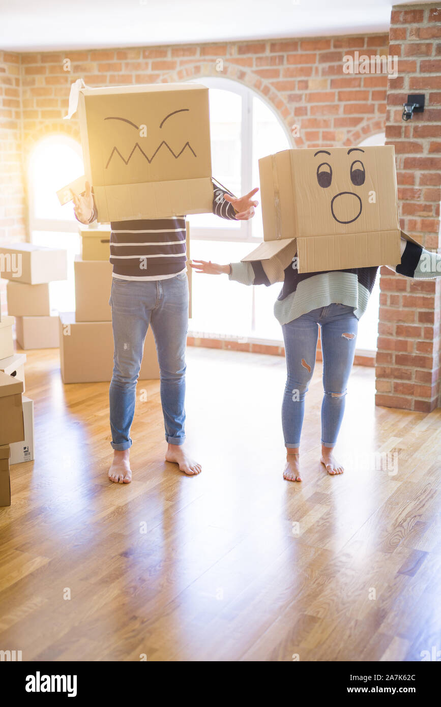 Beautiful famiily with kid playing with cardboard fanny boxes at new ...